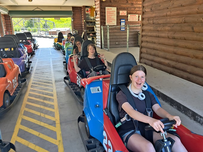 The pit lane experience: where every driver secretly contemplates which kart has the magical "fastest engine" before making their selection.