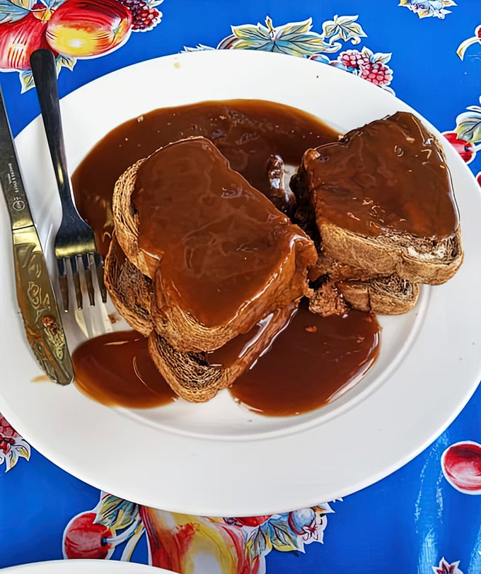 Meatloaf that would make your grandmother simultaneously proud and jealous, swimming in gravy that deserves its own fan club.