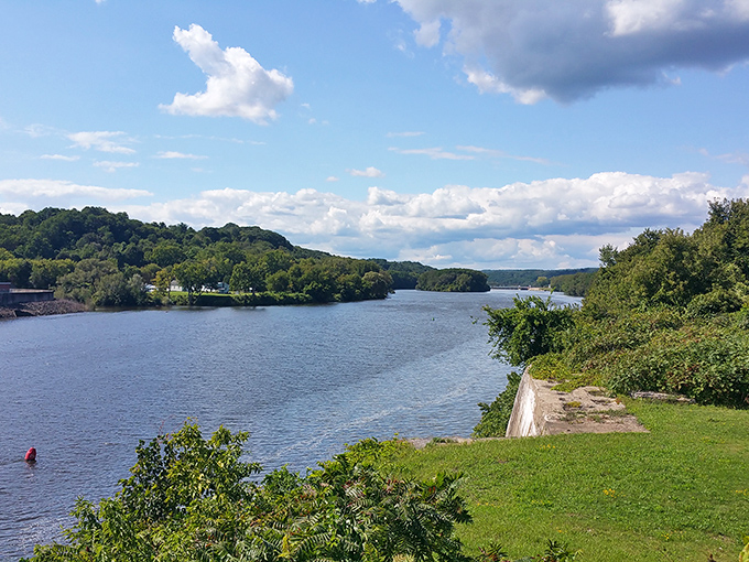The Mohawk River glides peacefully past Amsterdam's shores, offering waterfront views that elsewhere would require a hedge fund manager's salary.