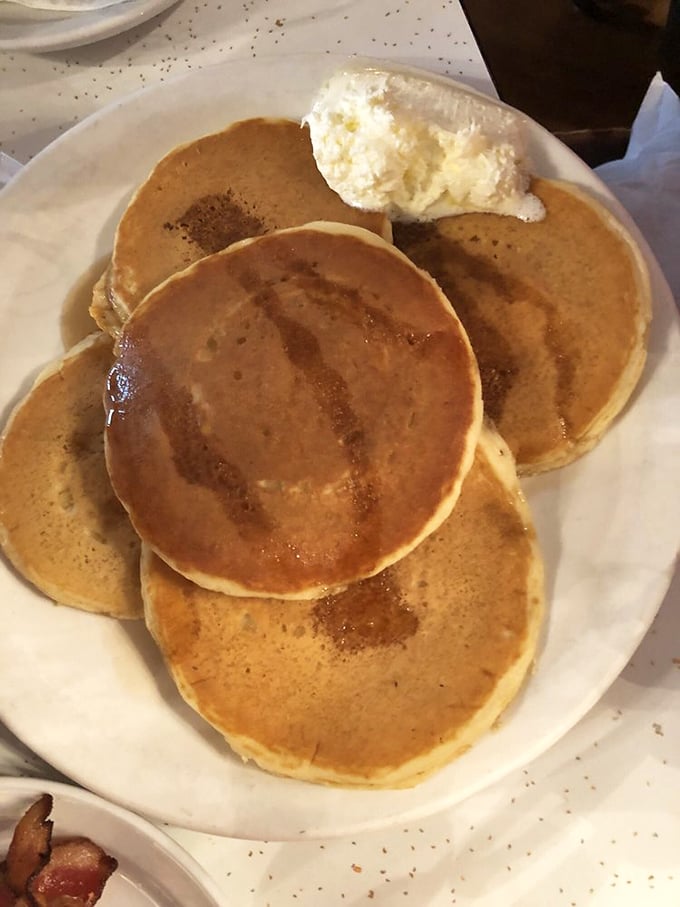 Golden-brown discs of happiness topped with a cloud of whipped butter. These aren't just pancakes; they're an edible Nashville tradition.
