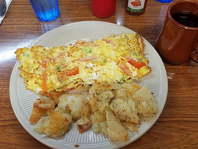 This isn't just an omelet &ndash; it's a golden canvas of perfectly cooked eggs cradling vegetables and cheese, with home fries that deserve their own Nevada state monument.