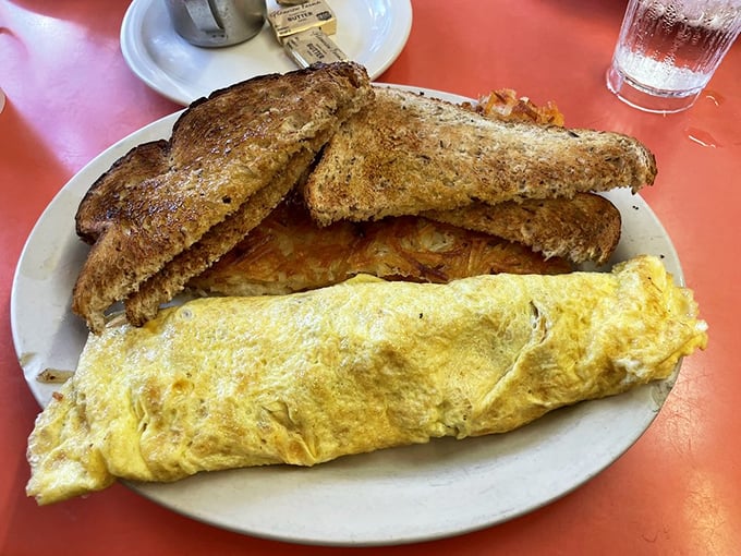 The omelet that launched a thousand satisfied sighs&mdash;perfectly folded, generously stuffed, and paired with toast that's achieved golden-brown nirvana.