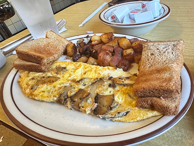 Mushroom omelet perfection: fluffy eggs embracing sautéed mushrooms with the kind of harmony that makes you wonder why breakfast can't be an all-day affair.