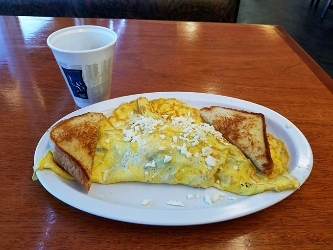 Behold the star attraction: a perfectly executed omelette that's fluffy yet substantial, with cheese that doesn't just melt but surrenders completely to the eggs.