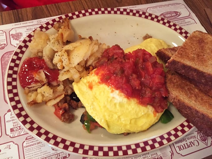 Behold the legendary omelette that locals swear by, golden and fluffy with home fries that could make a nutritionist weep tears of joy.