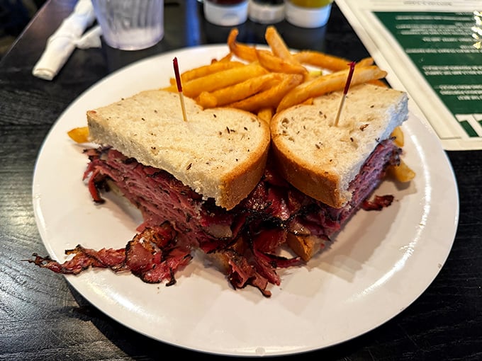 Behold the pastrami sandwich in all its towering glory, piled higher than your expectations and twice as satisfying.