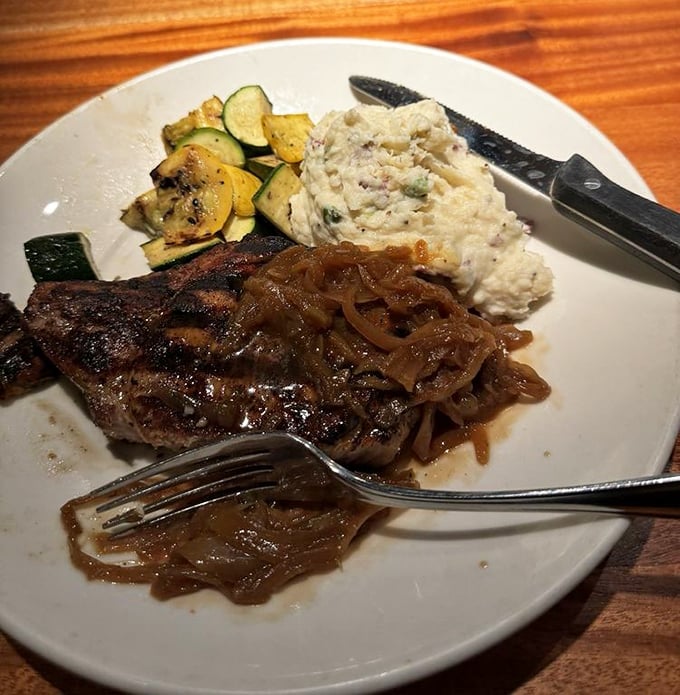 The star of the show: a perfectly seared pork chop with caramelized onions that makes time stand still.