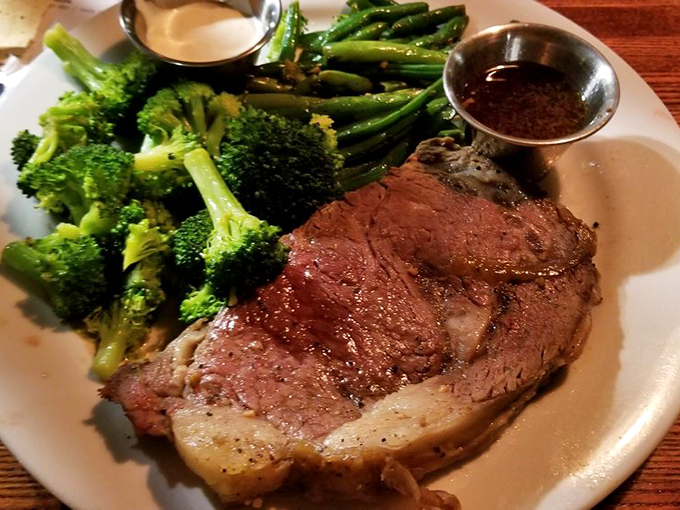 Prime rib so perfectly cooked it makes vegetarians question their life choices. Those vibrant green vegetables are just trying to keep up with the star of the show.