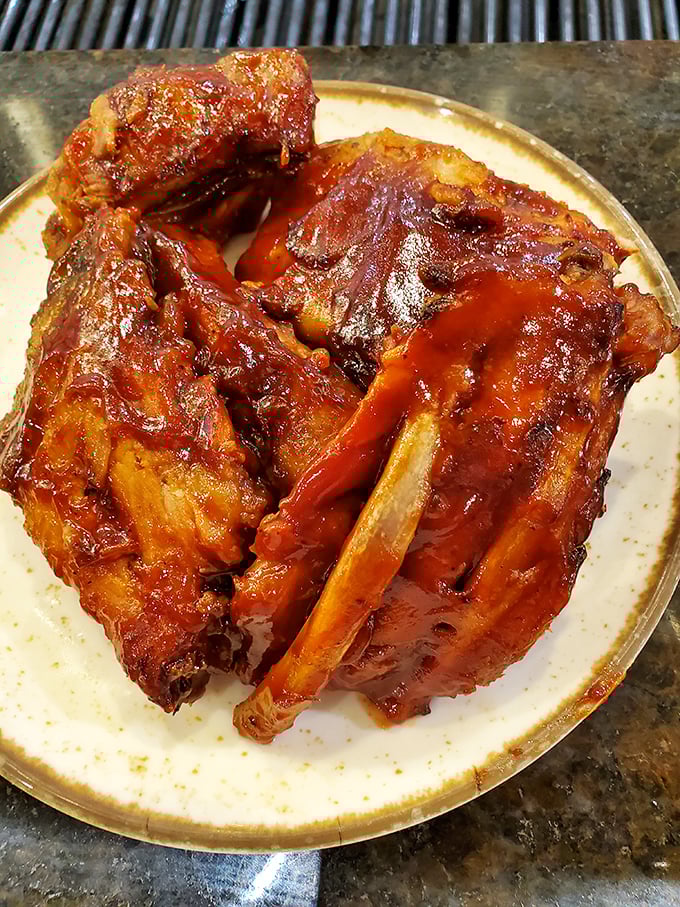 These glazed ribs aren't just falling off the bone—they're practically jumping onto your plate, glistening with a sauce worth every napkin you'll need.