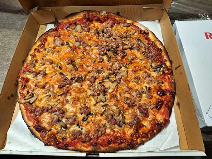 This isn't just pizza&mdash;it's edible architecture. The perfect balance of sausage, mushrooms, and that legendary charred crust will haunt your dreams.