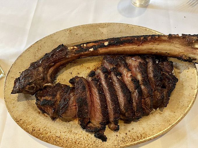 The tomahawk ribeye &ndash; nature's way of saying "go big or go home" &ndash; sliced to reveal that perfect medium-rare interior.