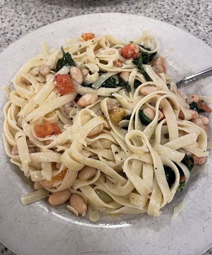 Fettuccine with white beans and spinach—where "healthy" and "indulgent" somehow manage to coexist on one perfectly twirled fork.