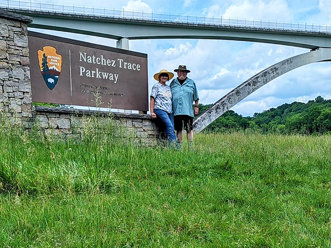 Explorers pause at the iconic Natchez Trace sign, proving that sometimes the best souvenirs aren't things you buy, but places you've been.