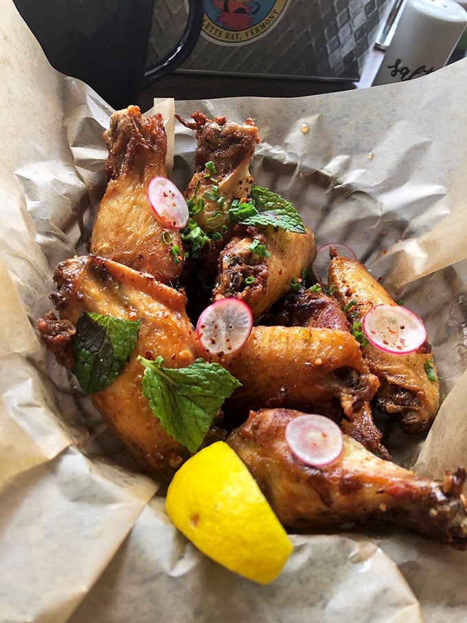 These aren't just wings; they're a masterclass in texture and flavor. The fresh herbs and radish slices aren't garnish&mdash;they're essential supporting actors in this culinary drama.