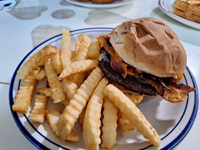 This isn't just a burger&mdash;it's edible architecture. The crispy fries standing at attention know they're in the presence of beef royalty.