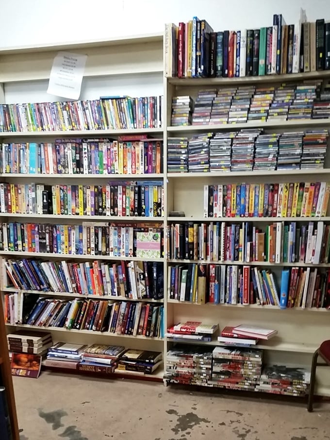 The literary corner rivals some small-town libraries. Your next favorite book is hiding here, probably next to someone's discarded self-help phase.