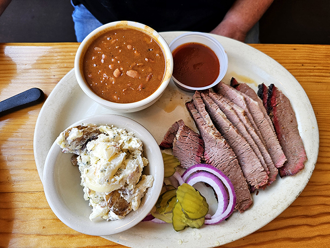 Brisket so tender it practically surrenders to your fork, served with creamy potato salad and beans that would make any Texan proud.