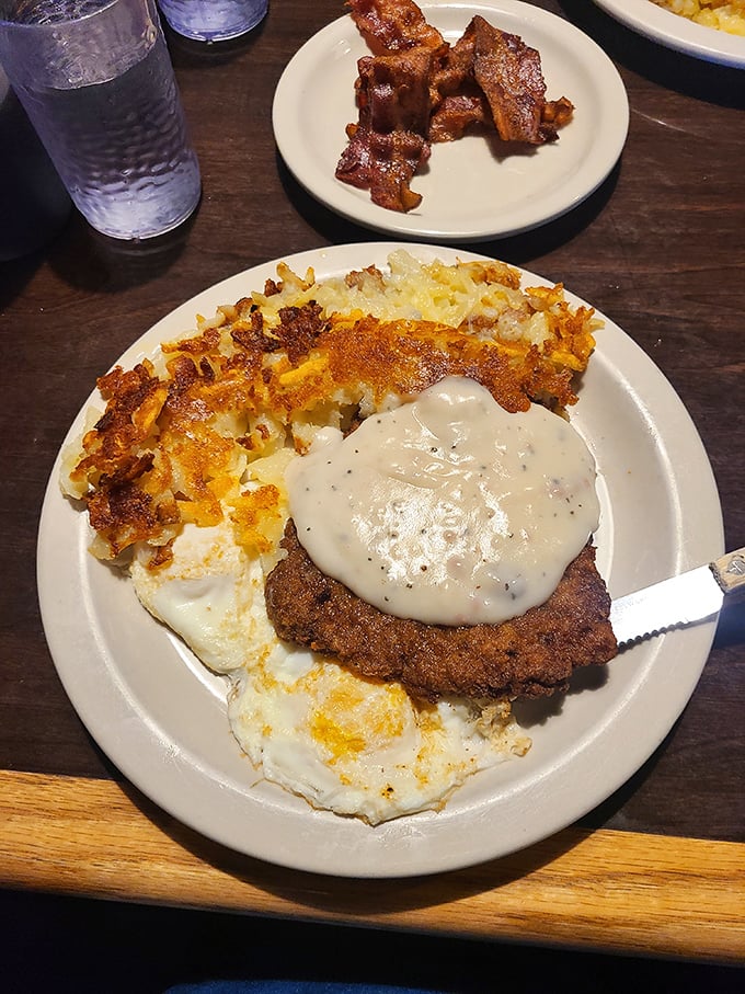 Country-fried steak smothered in peppery gravy alongside golden hash browns. Comfort food that hugs your soul from the inside.