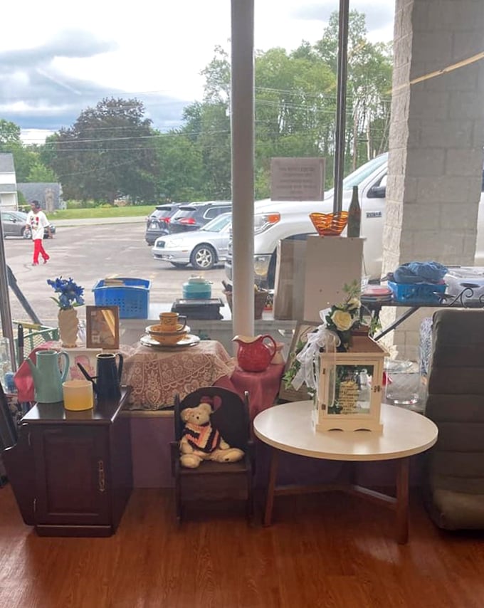 A cozy vignette near the window features a teddy bear holding court among vintage pitchers and decorative items &ndash; homey charm at its finest.