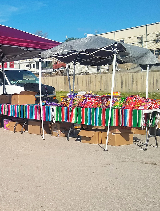 A vibrant Mexican serape transforms an ordinary folding table into a festive marketplace stall. The colors alone are worth the trip.