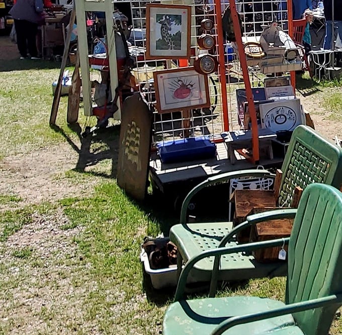 Green lawn chairs and framed artwork create an outdoor gallery effect. Who knew your next living room conversation piece would be waiting in a field in Adams?