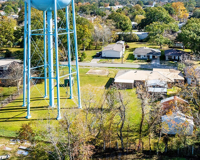 The iconic blue water tower stands sentinel over modest homes with spacious yards—real estate that wouldn't buy you a closet in Manhattan.