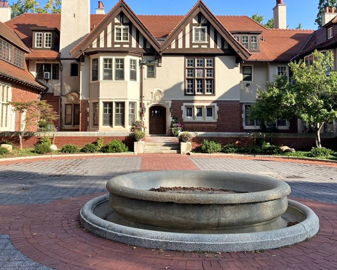 The entrance courtyard welcomes visitors with symmetrical charm and a circular fountain that seems to say, "Slow down, you've arrived somewhere special."