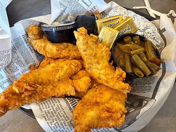 Golden-battered whitefish that shatters with each bite, served unpretentiously on newspaper—because sometimes perfection needs no fancy plate.