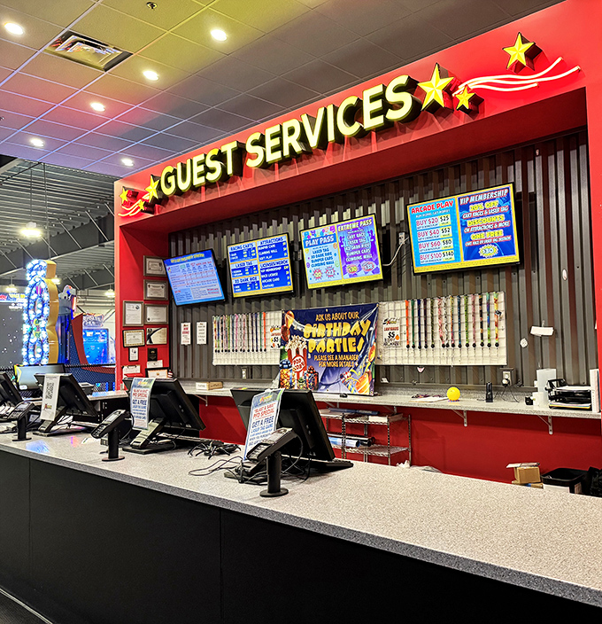 Command central for fun distribution, where the neon glow of "Guest Services" promises tickets, tokens, and temporary escape from reality.