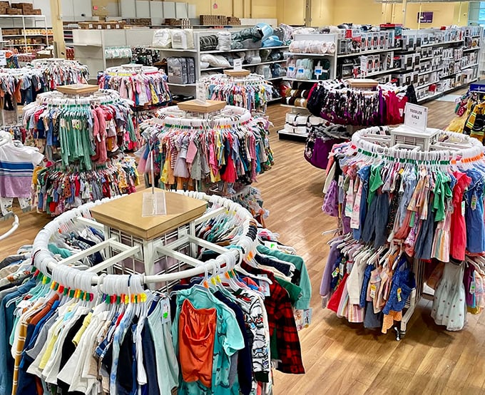 The children's clothing section: a rainbow of tiny fashions arranged in circular racks that make bargain hunting feel like a delightful treasure hunt.
