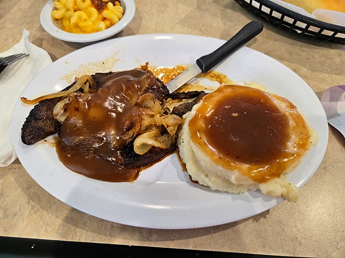 Liver and onions with mashed potatoes smothered in gravy—a dish that reminds you some comfort foods never needed reinvention, just respect.