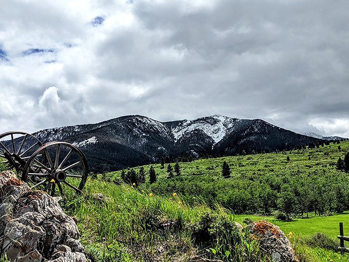 Montana's version of a screen saver: snow-capped peaks, rolling hills, and that wagon wheel saying, "Yep, this is the real West."