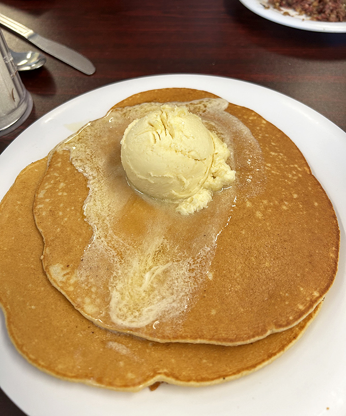 Golden pancakes crowned with slowly melting butter&mdash;proof that sometimes the simplest pleasures are the most profound.
