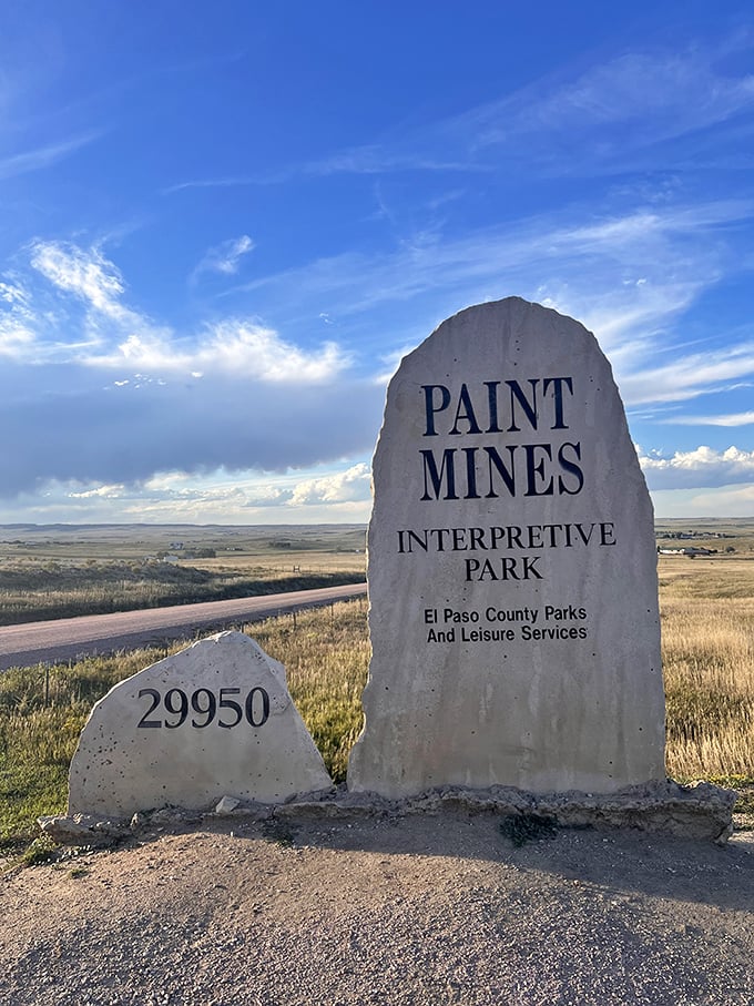 The unassuming entrance sign stands like a humble ma&icirc;tre d' introducing you to the geological feast that awaits beyond the prairie.