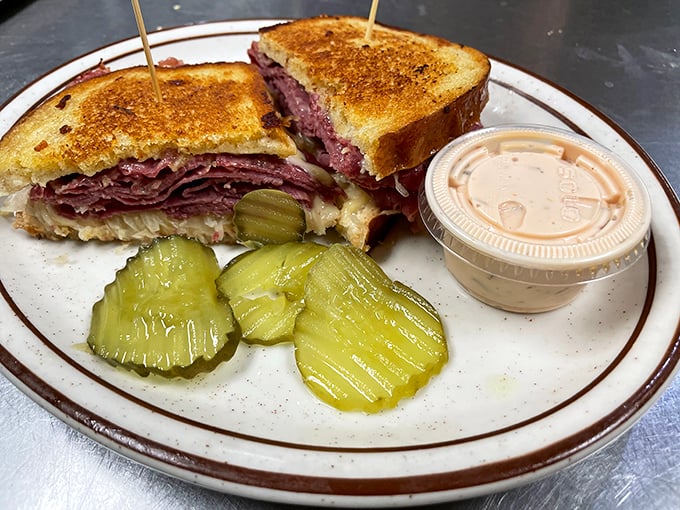 This Reuben isn't just a sandwich; it's an architectural marvel of perfectly grilled rye, corned beef, and sauerkraut that demands to be admired before devoured.