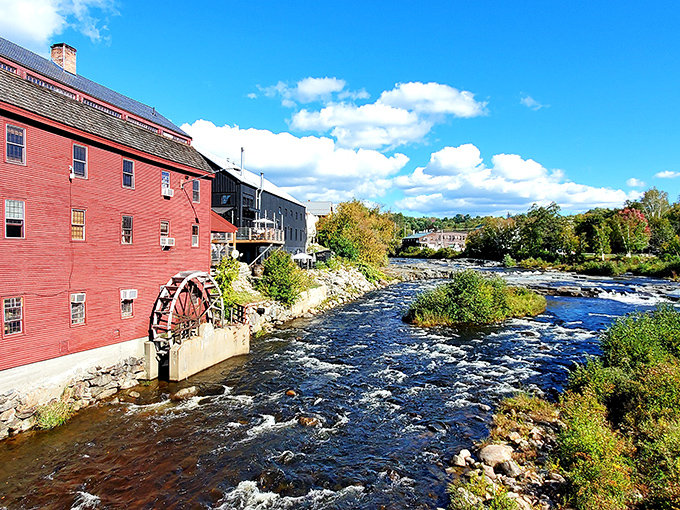 The historic red mill and water wheel alongside the Ammonoosuc River &ndash; industrial heritage transformed into postcard-perfect scenery.