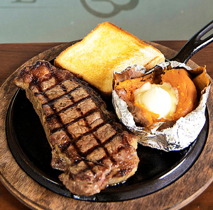 A perfectly grilled steak with a baked potato and Texas toast—the holy trinity of steakhouse perfection that needs no fancy introduction.