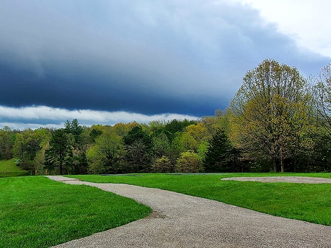 Storm clouds gathering over vibrant spring foliage&mdash;Mother Nature's dramatic lighting department working overtime to showcase Missouri's natural beauty.