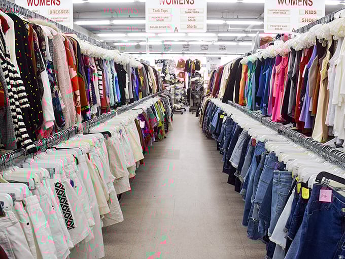 The women's clothing section stretches into infinity—a color-coded wonderland where vintage treasures hide between everyday basics like sartorial Easter eggs.