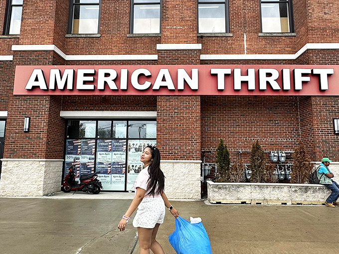 That cheerful shopper with her blue bag just struck thrift store gold in this brick building.