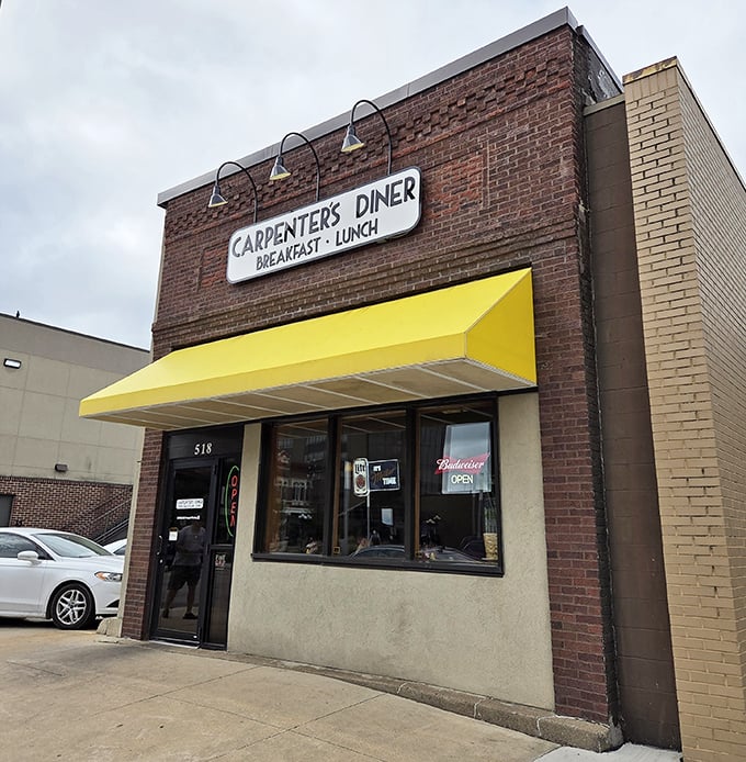 Carpenter's Diner's brick facade and cheerful yellow awning offer a morning welcome as warm as their fresh-poured coffee.