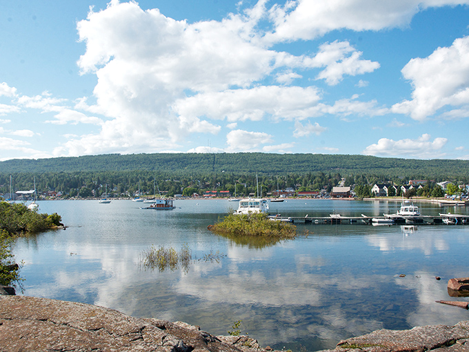Grand Marais harbor sparkles like a jewel on Lake Superior's edge, where boats bob gently against the backdrop of Minnesota's wild North Shore.