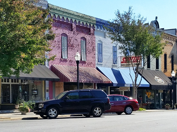 Colorful historic storefronts line Hartwell's main street, where striped awnings welcome visitors to small-town charm.