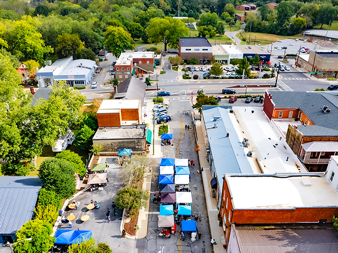 Jefferson's aerial view reveals a patchwork of community life, with colorful market tents bringing the downtown to life.