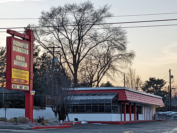 Olympus Burgers stands sentinel against the twilight sky. This red-signed temple of taste has been satisfying carnivorous cravings for generations.