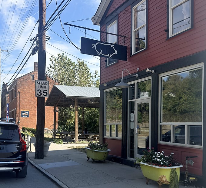 That simple pig silhouette sign says more than a fancy billboard ever could: authentic barbecue happens here.