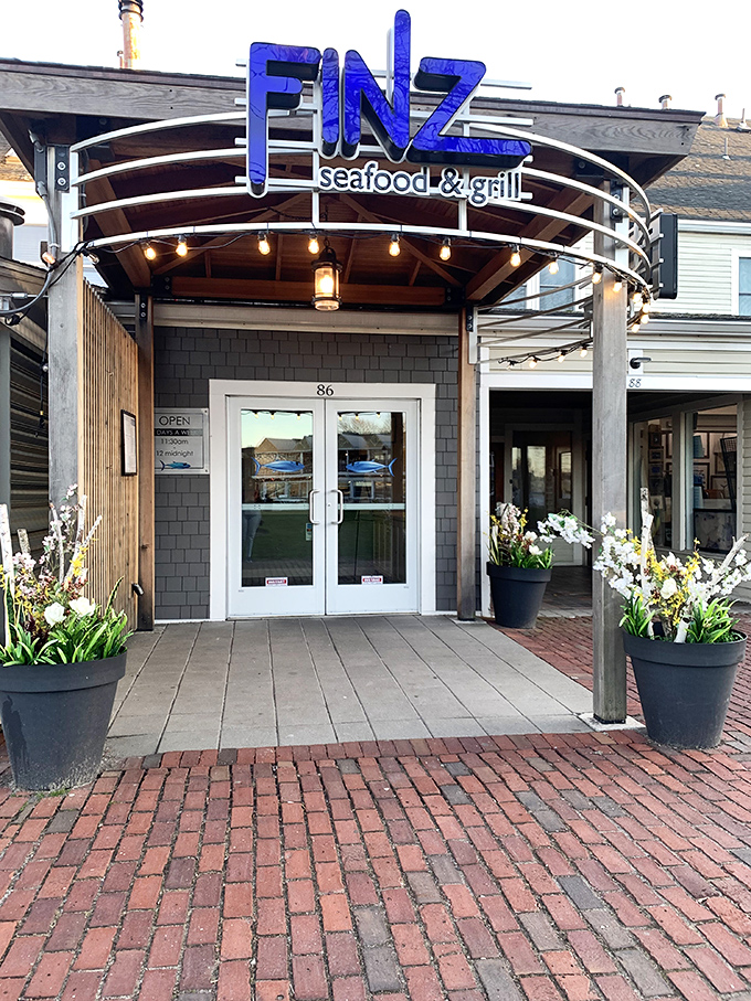 Modern meets maritime at Finz's inviting entrance. Those potted flowers say "Welcome" before you even reach the door.