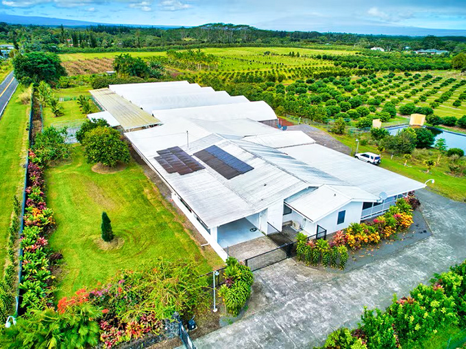 Agricultural facility surrounded by lush orchards and farmland in Kurtistown's fertile volcanic soil.