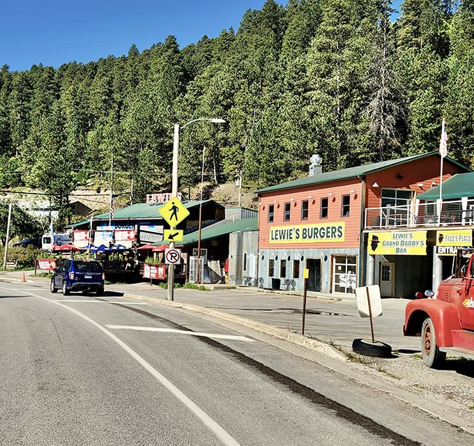 Lewie's Burgers nestled against pine-covered hills in Lead, South Dakota, with its rustic charm and small-town appeal.
