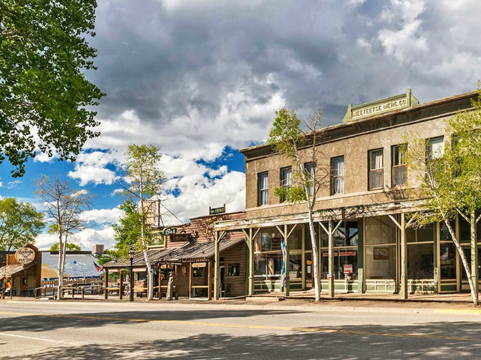Historic storefronts line the main street of this charming Wyoming town under dramatic skies.
